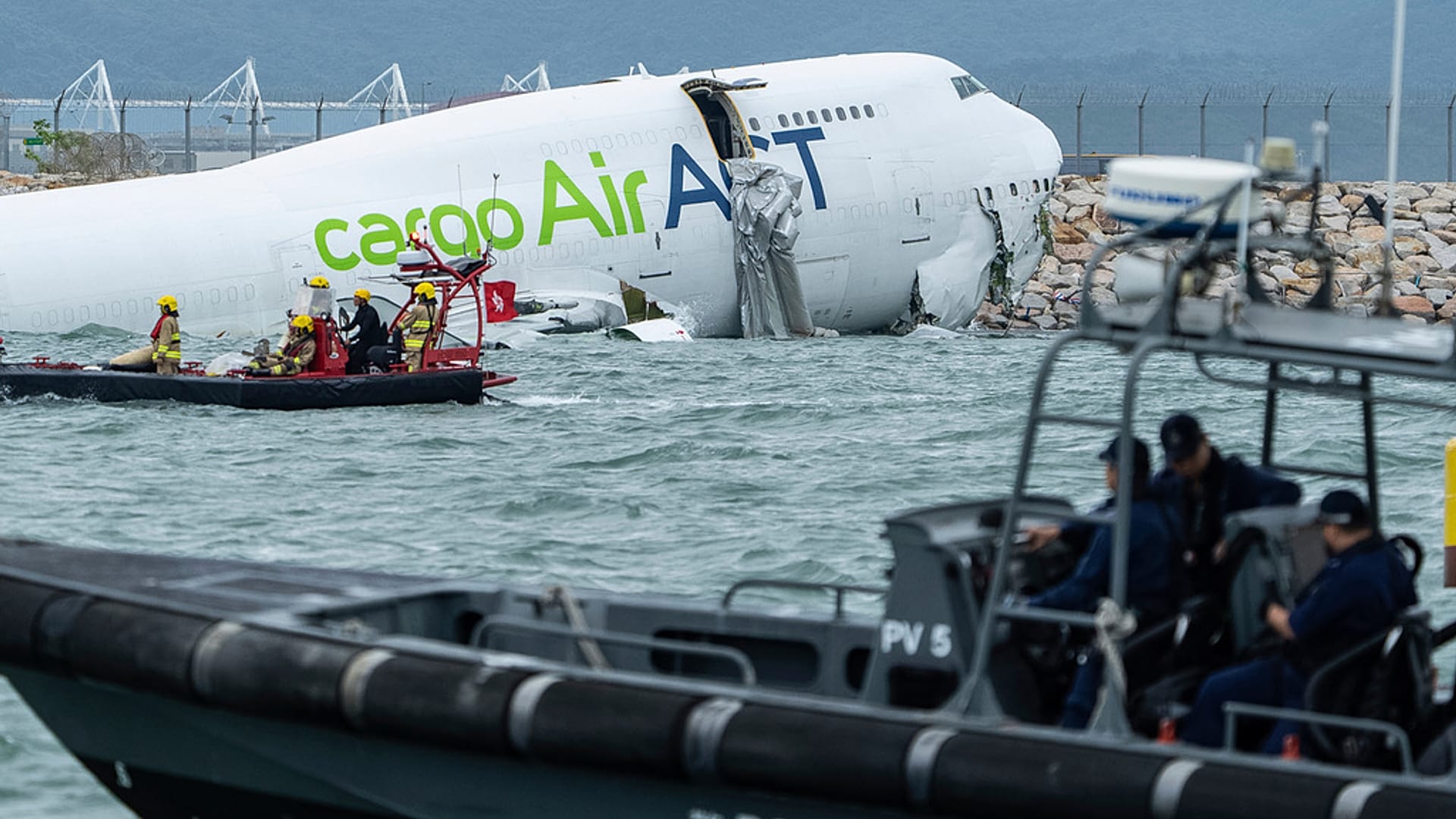 Two killed as cargo plane skids off runway and crashes into sea at Hong ...