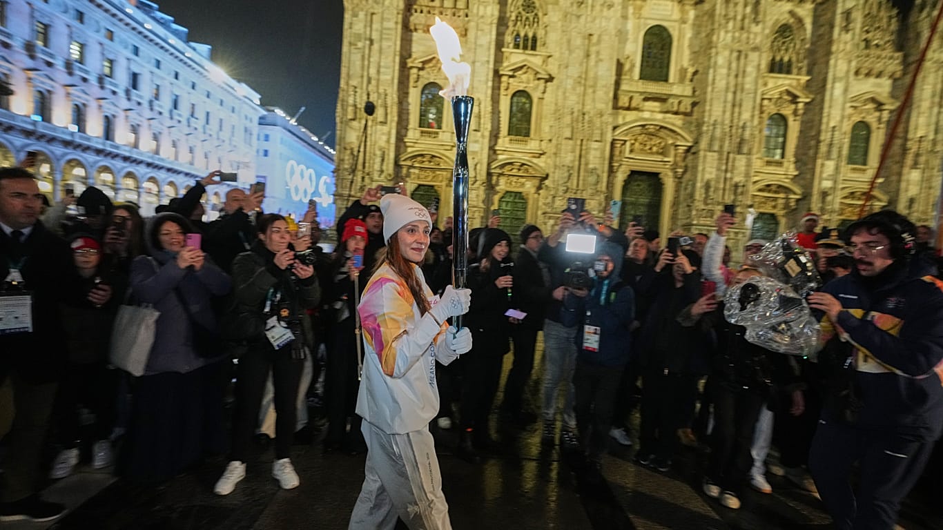 Video. Winter Olympics flame lights up Milan as crowds pack Piazza ...